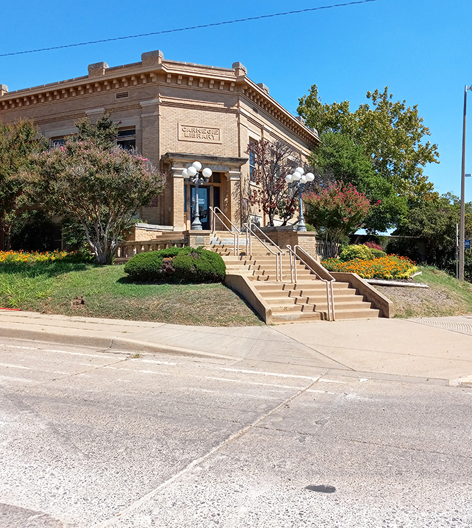Carnegie Library stands as an architectural gem surrounded by seasonal blooms, proving that even knowledge itself ages gracefully in Lawton.