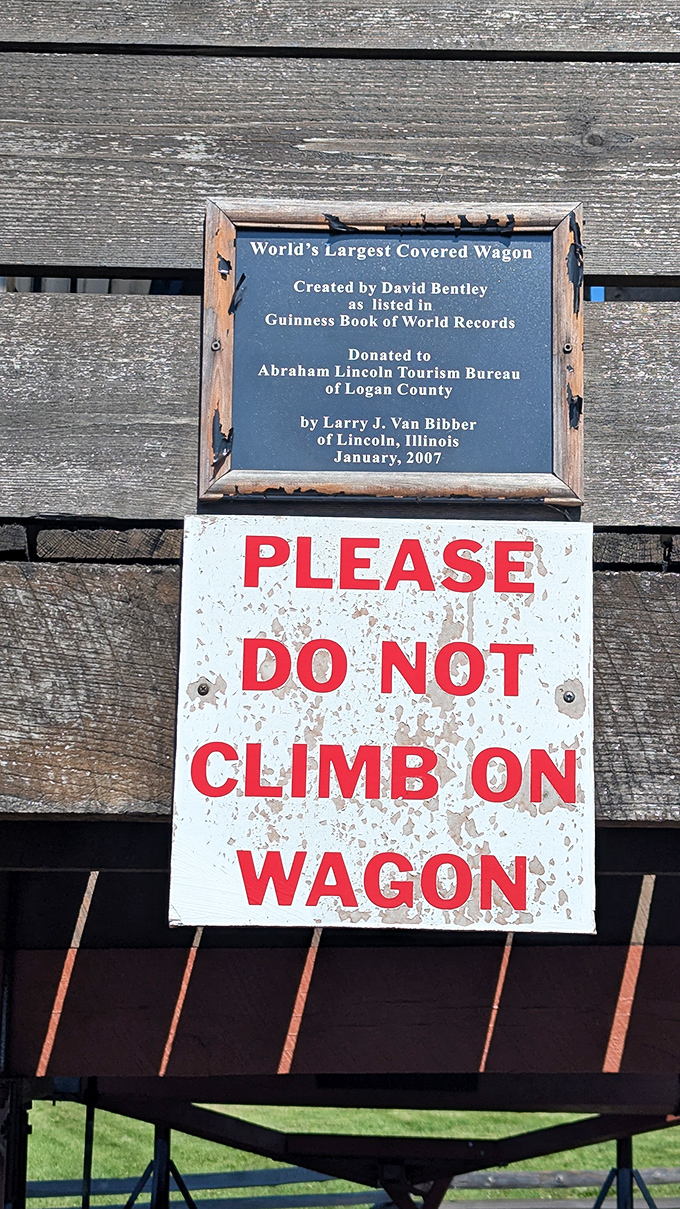 "Please do not climb on wagon" might be the most necessary yet ignored sign in Illinois. The temptation to scale this wooden mountain proves irresistible to many.