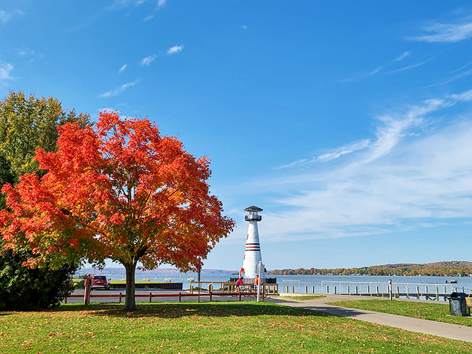 Fall foliage frames Celoron Lighthouse on Chautauqua Lake, nature's way of showing off without sending you a bill.