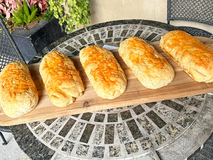Cheese-topped bread loaves lined up like soldiers ready for the delicious battle against hunger.