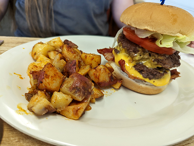 A burger that makes you question why we ever decided some foods were just for lunch—paired with home fries that refuse to be overshadowed.