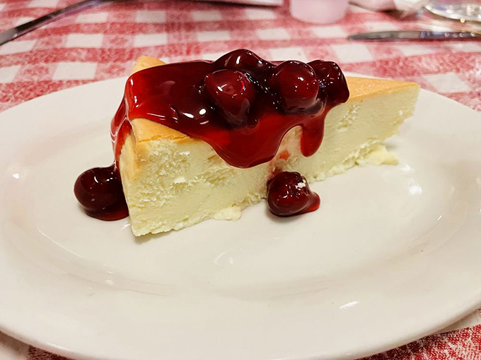 Cheesecake draped in cherry sauce &ndash; the sweet finale that somehow finds room in your stomach even when you swore you couldn't eat another bite.
