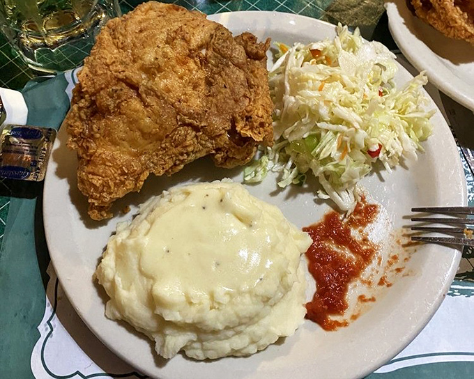 The complete experience: golden fried chicken, creamy mashed potatoes, and fresh coleslaw. This isn't just a meal &ndash; it's an Indiana institution on a plate.