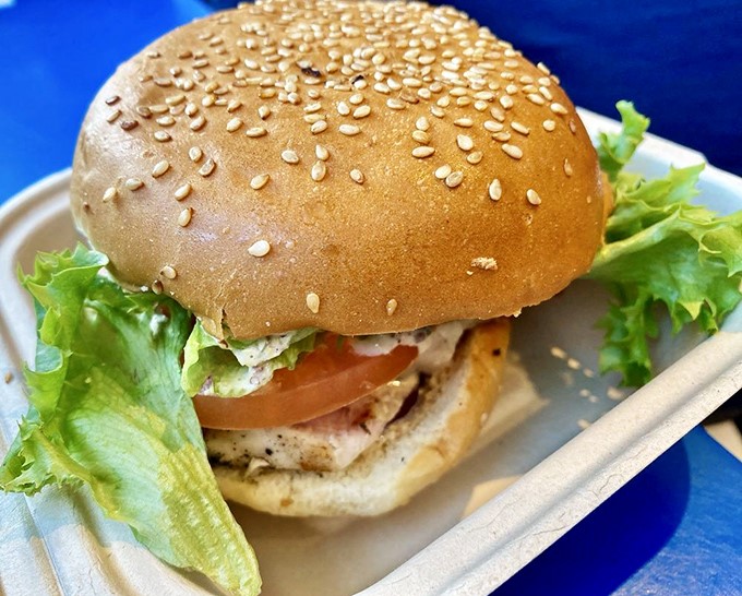 A chicken sandwich that doesn't apologize for not being seafood. Perfectly grilled, generously dressed, and surprisingly at home in this ocean of options.