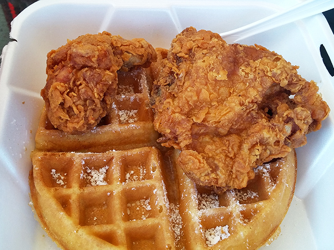 The star of the show: golden chicken perched atop a powdered waffle. This isn't just breakfast meets dinner&mdash;it's a flavor marriage made in heaven.