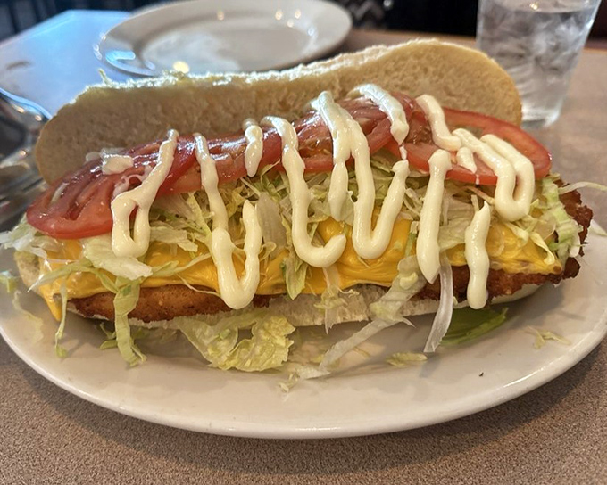 A chicken sandwich that's dressed better than most people at the airport. That drizzle of sauce is the jewelry that completes this edible outfit.