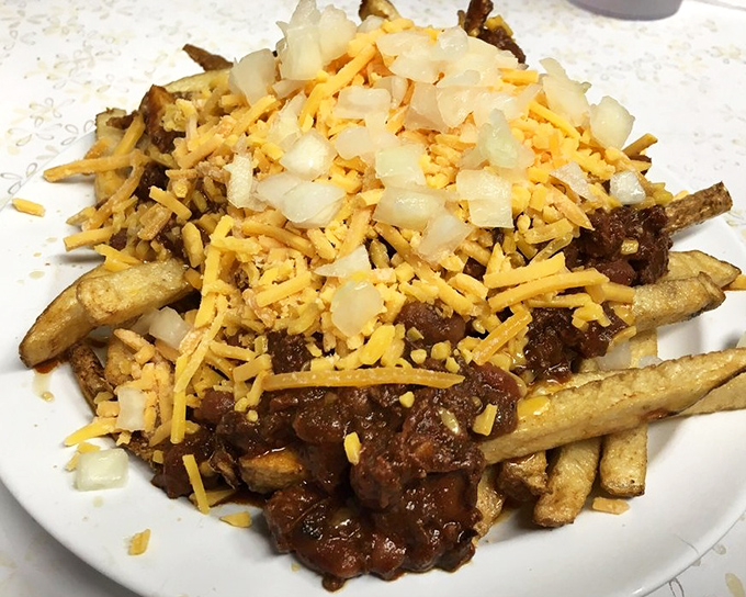 Chili cheese fries topped with onions, because if you're going big, you might as well go all in.