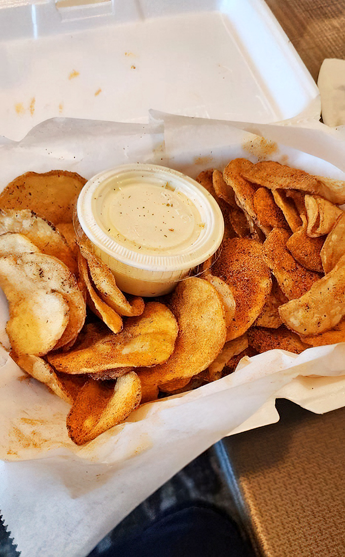 House-made chips with dipping sauce—because sometimes potatoes achieve their highest purpose after meeting hot oil.