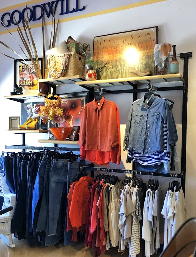 A fashion treasure trove awaits! Neatly organized racks showcase denim, bright orange blouses, and striped shirts&mdash;proof that sustainable style doesn't require a second mortgage.