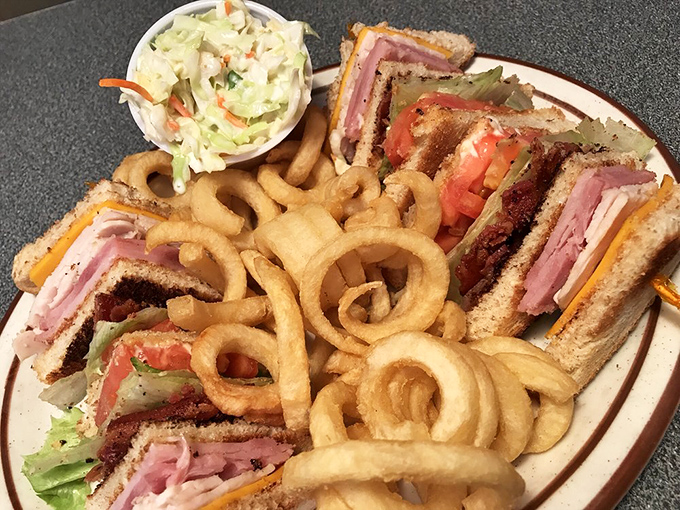 The club sandwich: a skyscraper of flavor held together with toothpick engineering that would impress Frank Lloyd Wright.