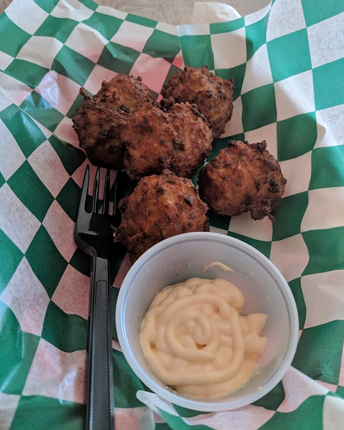 These conch fritters look like they've been working out at the deep-fryer gym. That creamy sauce is their protein shake for maximum flavor gains.