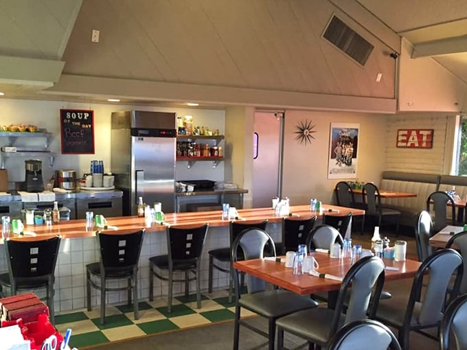 Counter seating with checkered floors that scream authentic diner experience, perfect for solo diners seeking breakfast conversation.