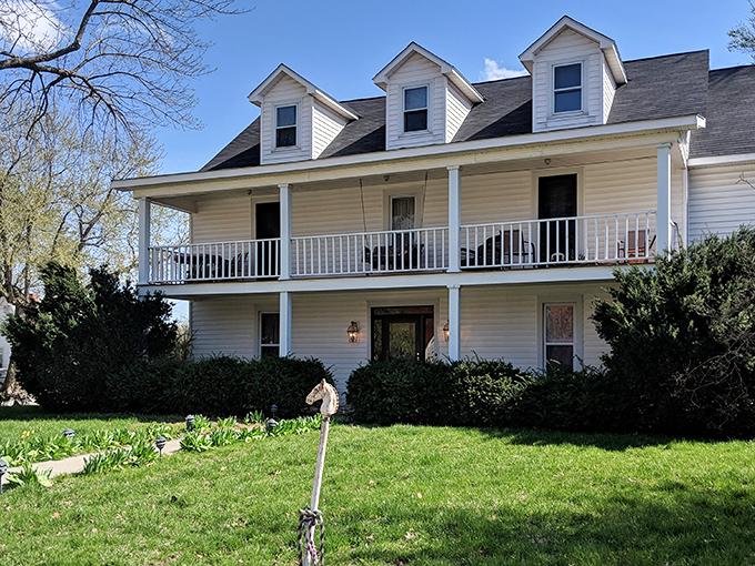 This stately country home with its welcoming porch represents the architectural equivalent of a warm hug from your favorite grandparent.