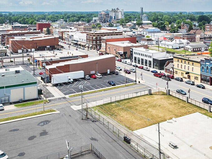 This aerial view reveals Delphos's perfect small-town layout, with its grid of streets and mix of historic and modern buildings nestled in Ohio's verdant landscape.
