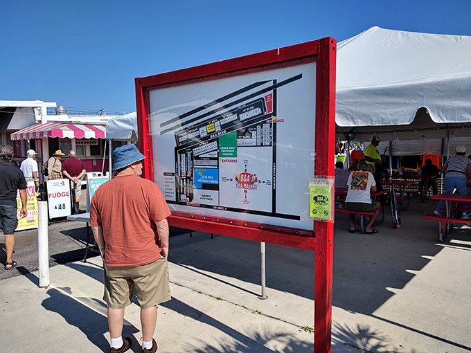A shopper studies the market map, planning his bargain-hunting strategy like a general preparing for a particularly delightful battle.