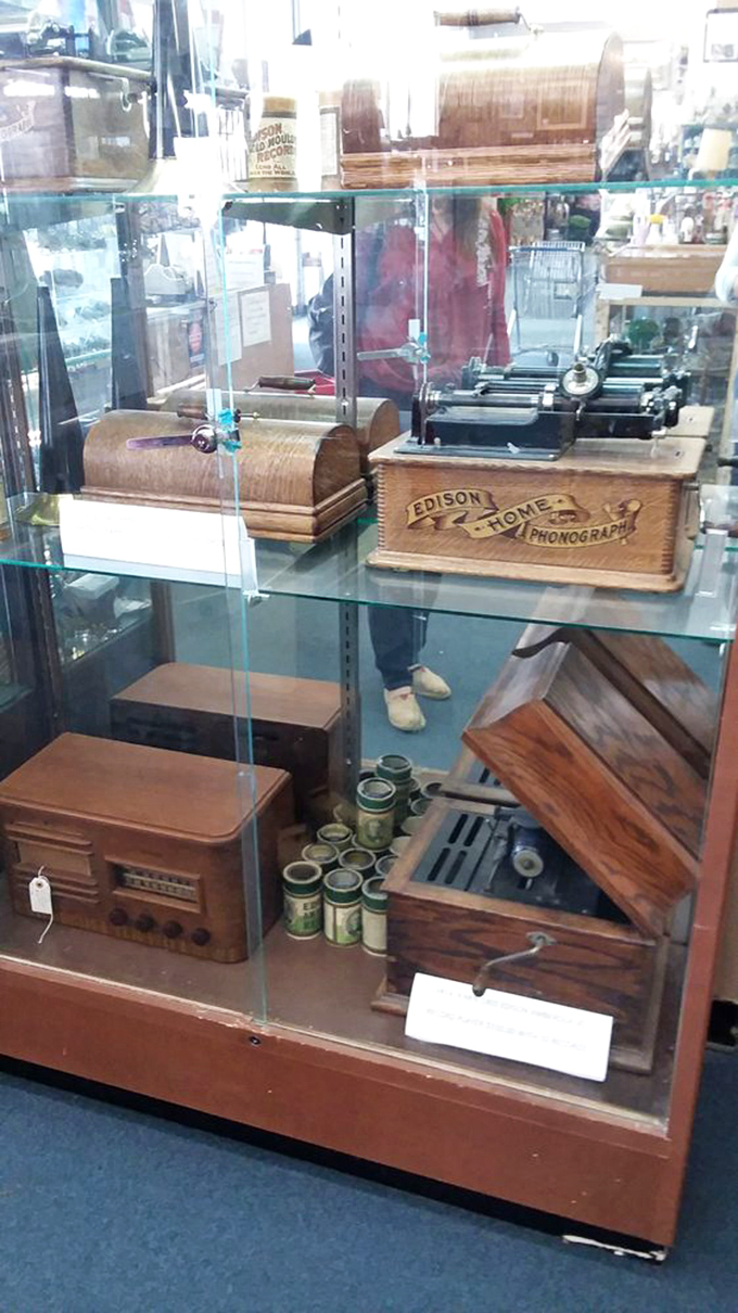 Edison's phonograph sits in dignified retirement, a reminder that before Spotify, music came in wooden boxes with mechanical wonder.