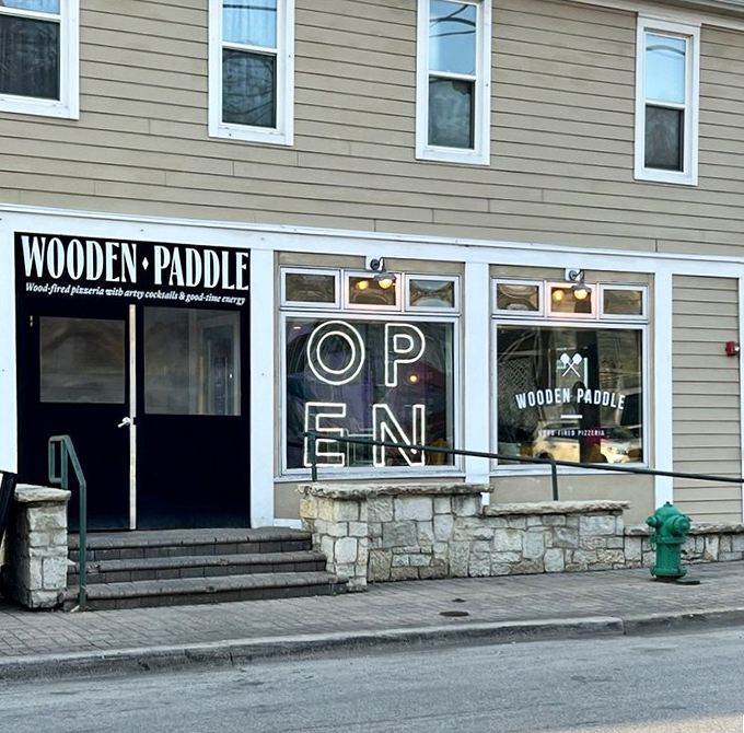 The entrance beckons with its stone facade and that "OPEN" sign that might as well say "happiness available inside."