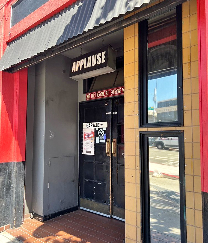 The entrance doesn't just say "APPLAUSE"&mdash;it predicts your reaction after the meal. That sign knows exactly what's about to happen to your taste buds.