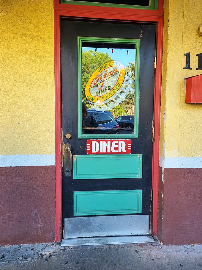 That iconic bottle cap logo on the door is like a wink from an old friend, promising that everything's going to be alright once you step inside.