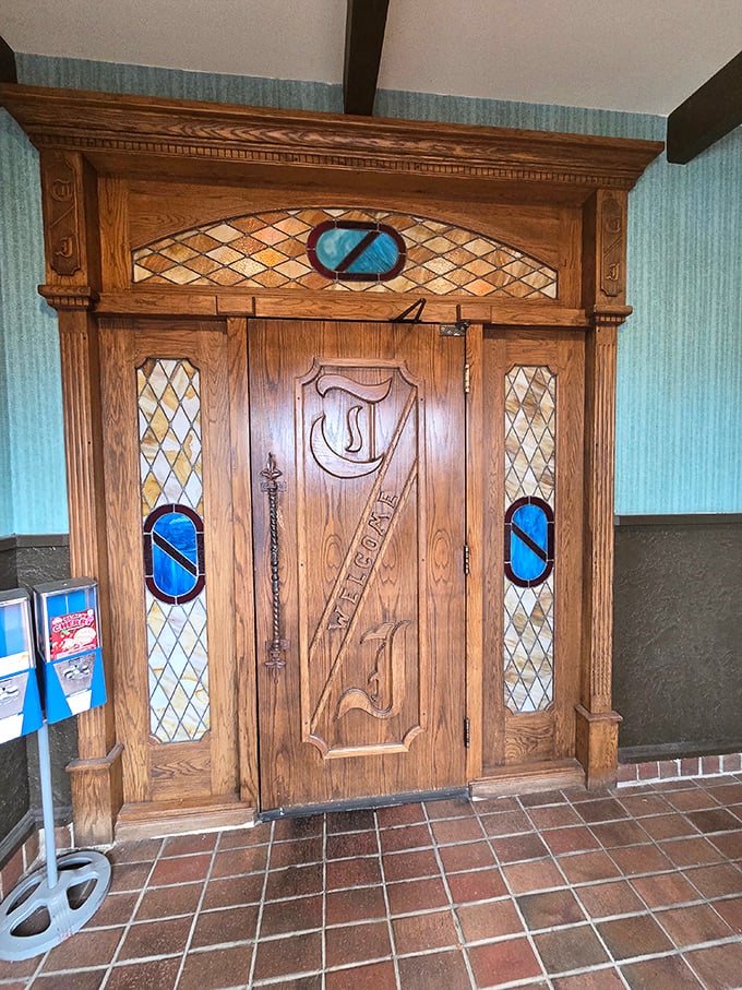 An entrance door worthy of a medieval castle or speakeasy, complete with stained glass and ornate woodwork&mdash;the perfect portal to old-school dining excellence.