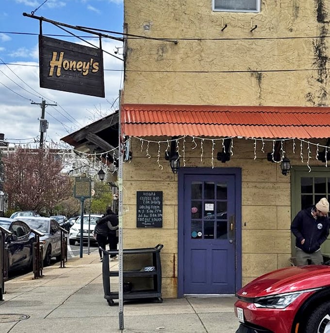 The wooden sign says "Honey's" but might as well say "Home." That purple door welcomes you like an old friend.