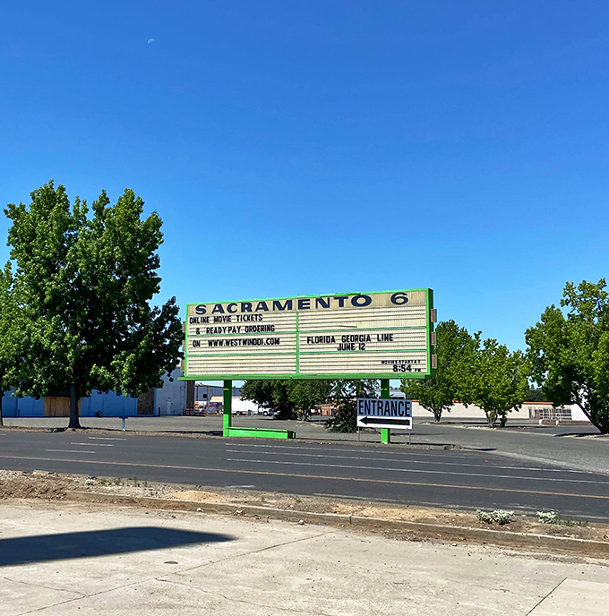 The marquee announces tonight's features under a perfect California sky, standing tall as both landmark and invitation to Sacramento's outdoor cinema paradise.