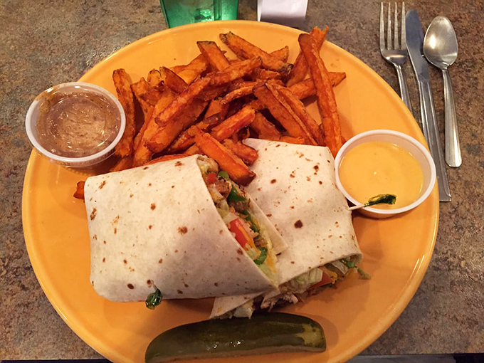 A wrap that's achieved perfect structural integrity, paired with sweet potato fries that make regular potatoes wonder what they did wrong.