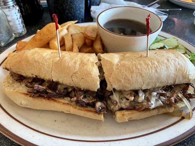 The French Dip at Chubby's&mdash;where thinly sliced beef meets its soulmate in a crusty roll, with a side of au jus for that perfect dipping romance.