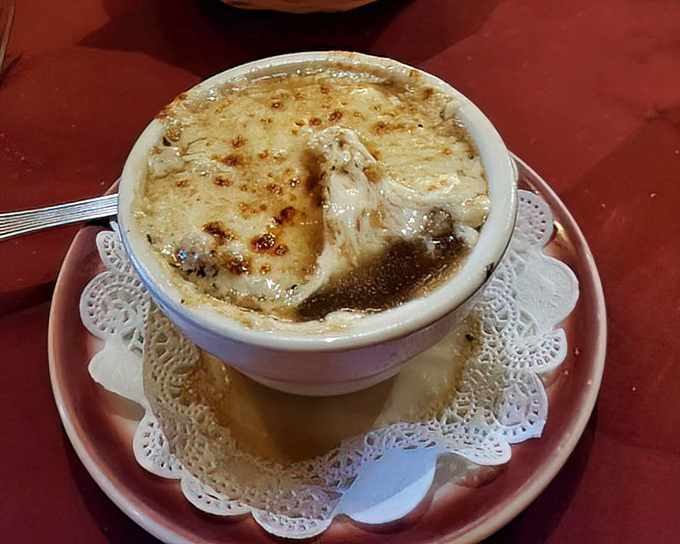 French onion soup with a cheese cap so perfect it deserves its own superhero cape. The ultimate comfort in a bowl.