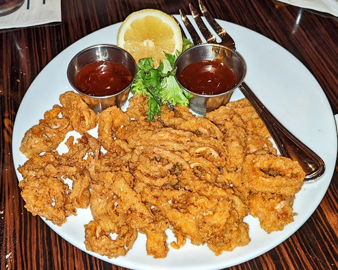 Fried calamari that defies the rubbery reputation &ndash; crispy, tender, and ready for its close-up with those dipping sauces.