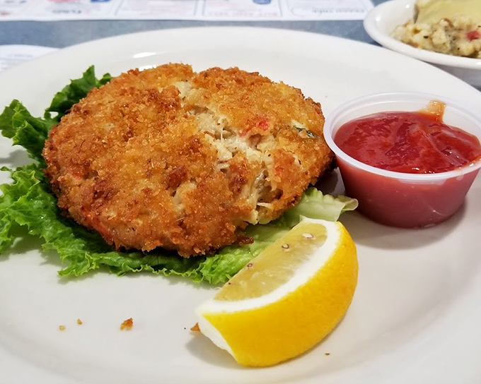 A golden-fried crab cake that's more crab than cake, served with the respect it deserves on a bed of crisp lettuce.