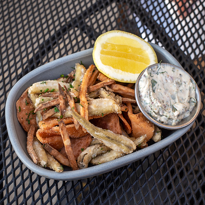 Golden fried smelts served with lemon and tartar sauce prove that sometimes the simplest preparations are the most deeply satisfying choices.