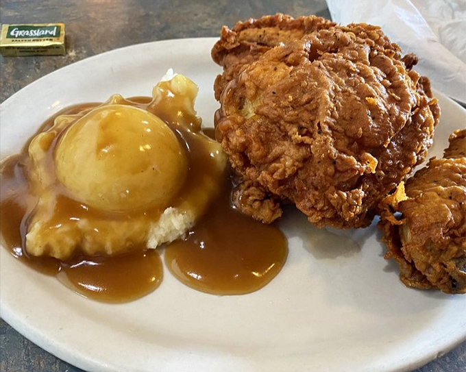 Golden-fried chicken beside a mountain of mashed potatoes&mdash;comfort food that whispers "everything's gonna be alright" with every bite.