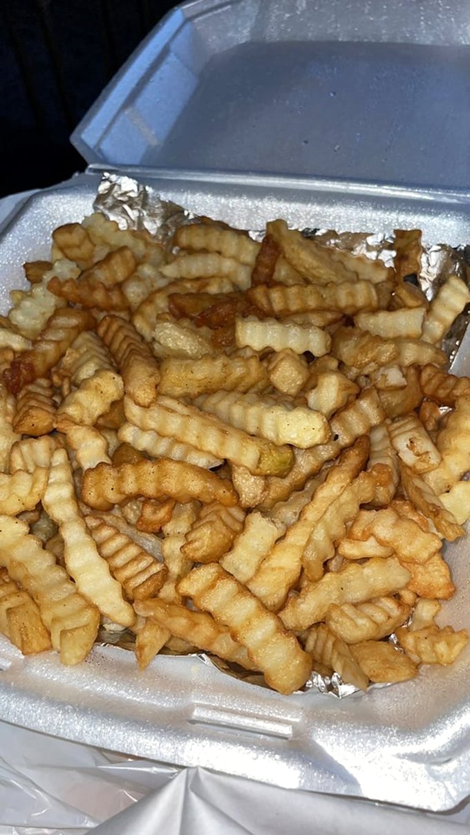 Crinkle-cut fries that achieve the golden trifecta: crispy exterior, fluffy interior, and just enough salt to make you reach for another.