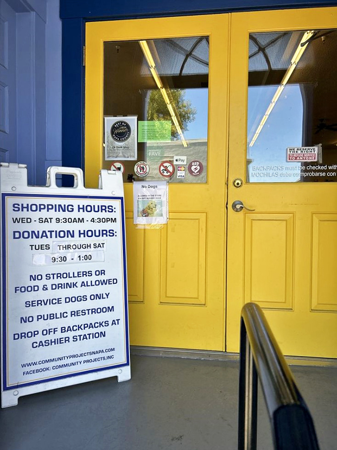 The cheerful yellow door welcomes bargain hunters with clear hours and rules &ndash; no strollers, but endless possibilities await inside.