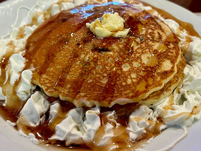 These golden pancakes surrounded by whipped cream aren't breakfast &ndash; they're dessert with permission to eat it before noon.