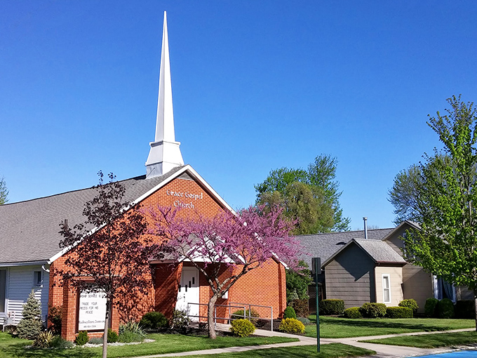 Grace Gospel's pristine steeple reaches skyward, surrounded by spring blossoms that seem to echo the community's spiritual devotion.