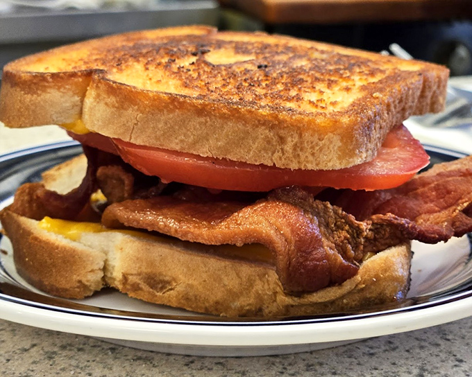 The humble grilled cheese elevated to art form&mdash;golden-brown perfection housing melted cheese and bacon that would make any rainy day better.