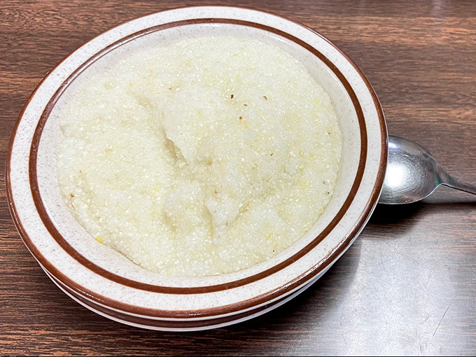 Grits so creamy they could make a Southerner weep with joy. This humble bowl contains more comfort than most therapy sessions, at a fraction of the cost.