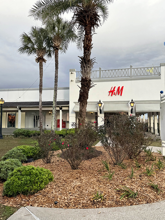 H&M framed by palm trees and southern landscaping &ndash; fast fashion meets slow southern charm.