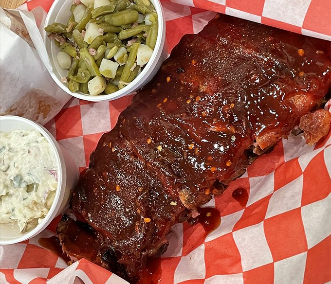 Ribs with a glaze so shiny you could check your reflection before diving in. The side of slaw isn't garnish&mdash;it's necessary balance.
