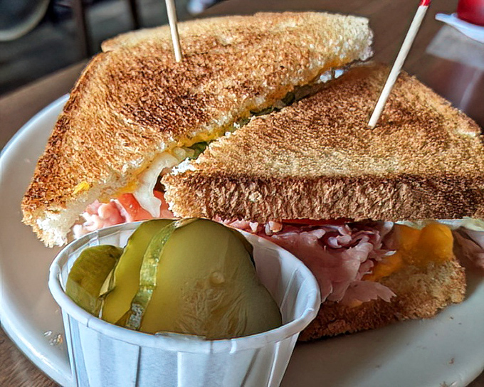 The humble grilled ham and cheese with house-made pickles proves that Zip's mastery extends well beyond their famous burgers.