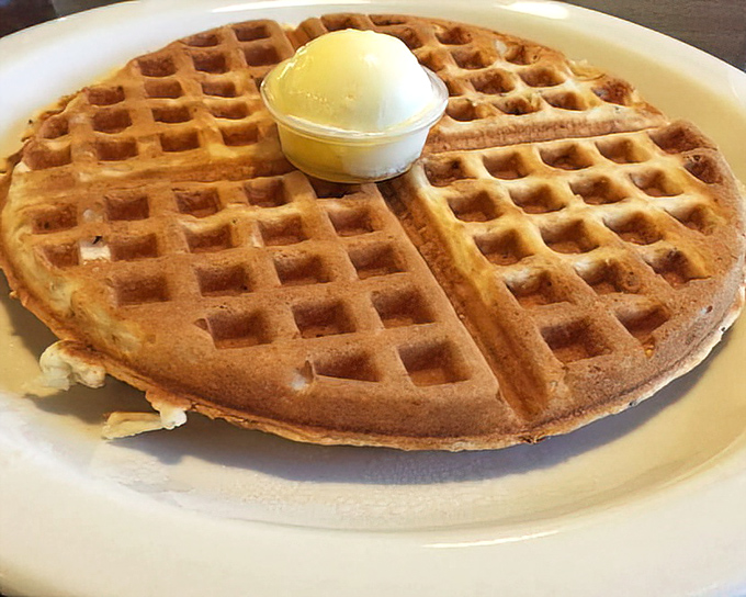 A waffle that's achieved the impossible: crisp exterior, fluffy interior, and the structural integrity to support that perfect scoop of butter.