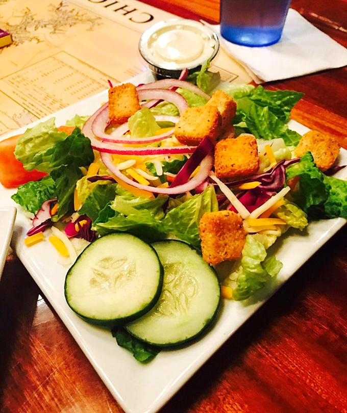 A house salad that didn't get the memo about being boring. Those crisp vegetables and vibrant colors are like a garden party on a plate. 