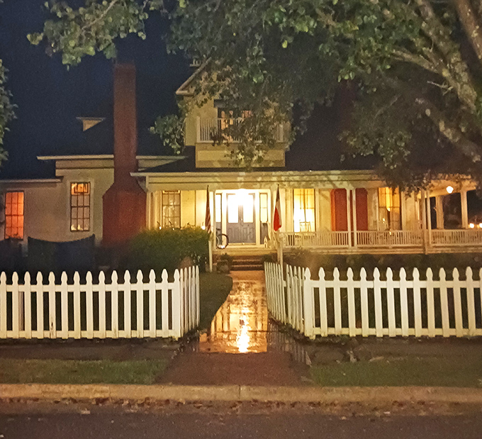 As night falls, historic homes like this one transform from charming daytime attractions into atmospheric settings for Jefferson's famous ghost tours.