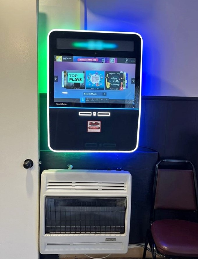 The modern jukebox stands in contrast to the vintage surroundings, bridging generations of diners who've found comfort here.