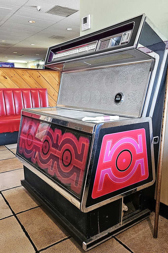 The vintage jukebox stands guard like a sentinel of nostalgia, ready to provide the soundtrack to your pancake experience for just a quarter.