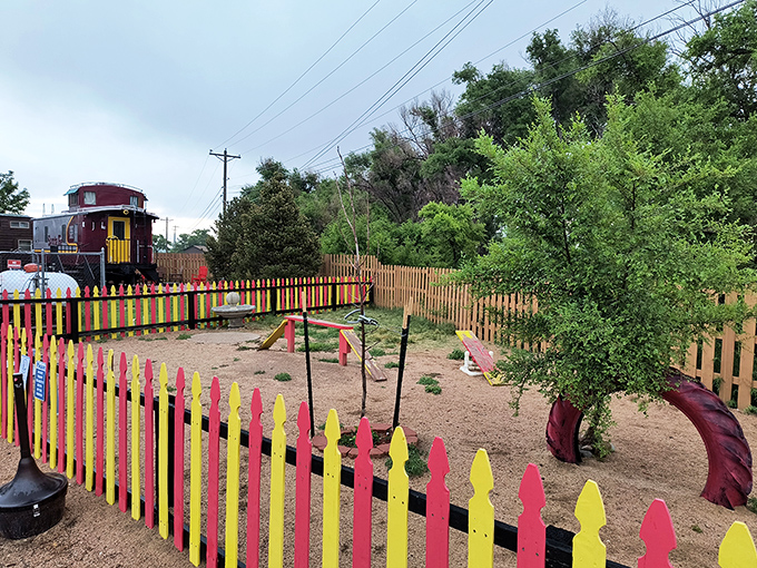 This colorful playground beside a vintage caboose reminds us that sometimes the simplest joys&mdash;like slides and imagination&mdash;are the ones we remember forever.