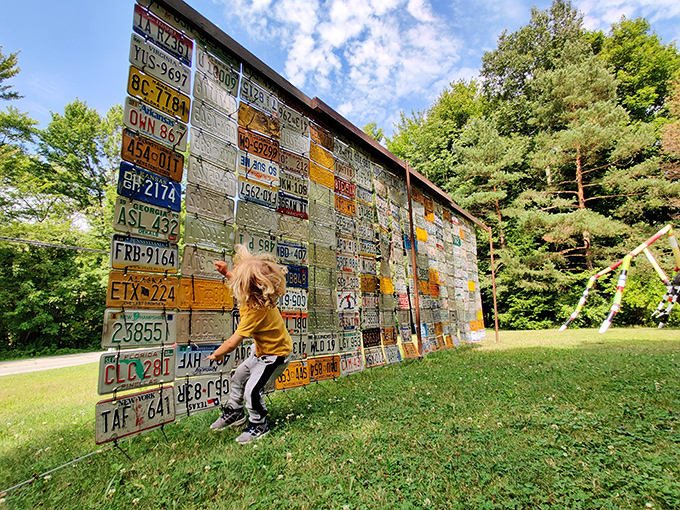 A wall of automotive history told through license plates becomes an interactive timeline, inviting visitors to touch the past while imagining road trips taken.