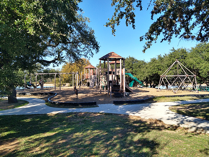 This playground waits patiently for children's laughter, standing ready in the Texas sunshine like a promise of afternoon adventures.